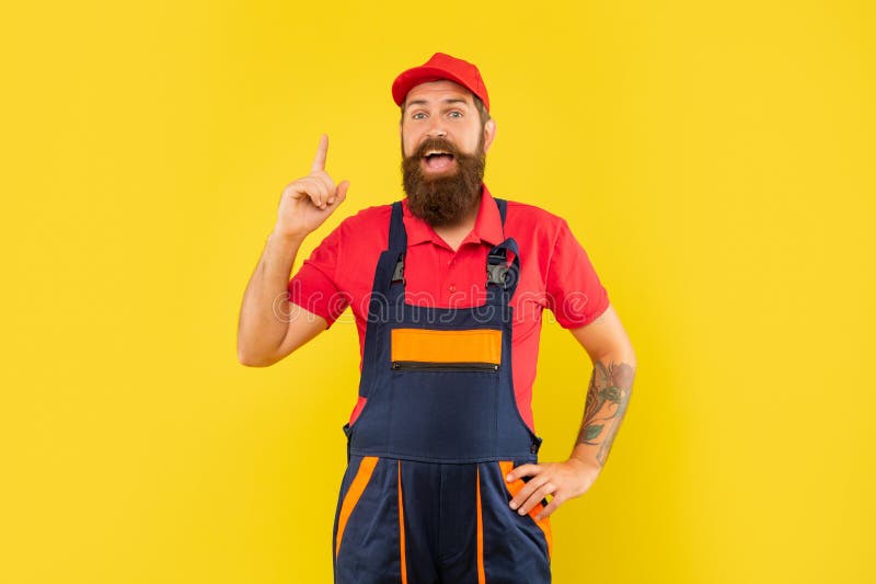 Inspired Bearded Man Plumber in Work Clothes on Yellow Background Stock ...