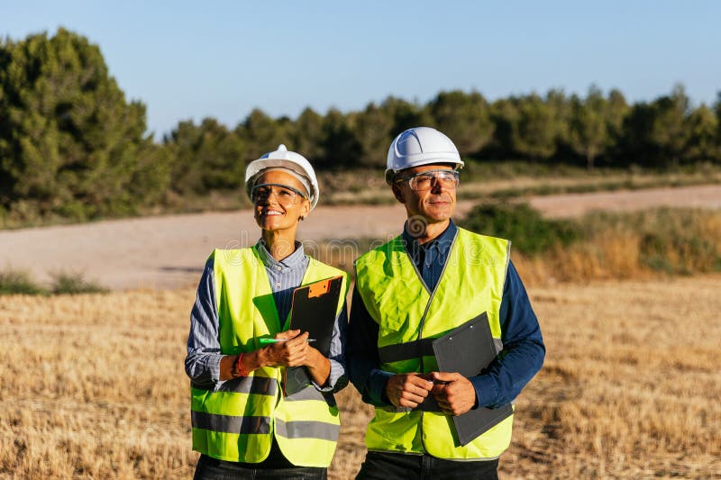 Inspired Engineers at Work on Windmill Farm. Stock Photo - Image of ...