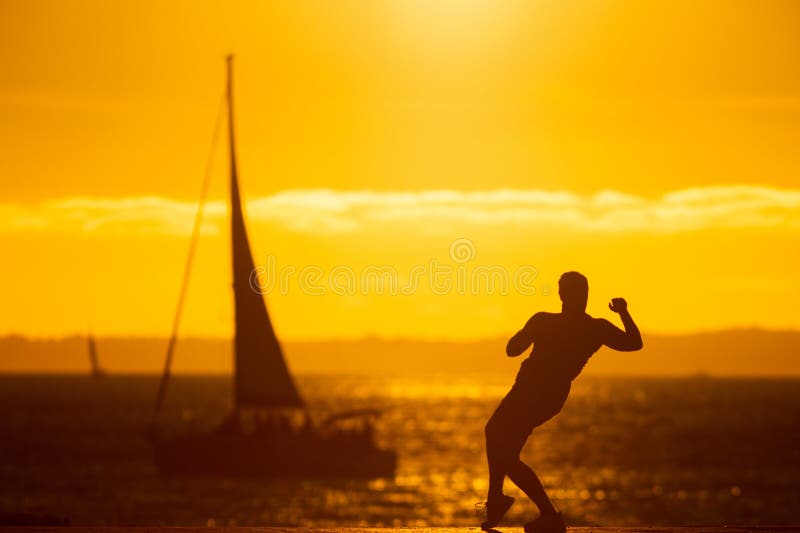 An Inspired Man Dancing on the Waterfront at Sunset Stock Photo - Image ...