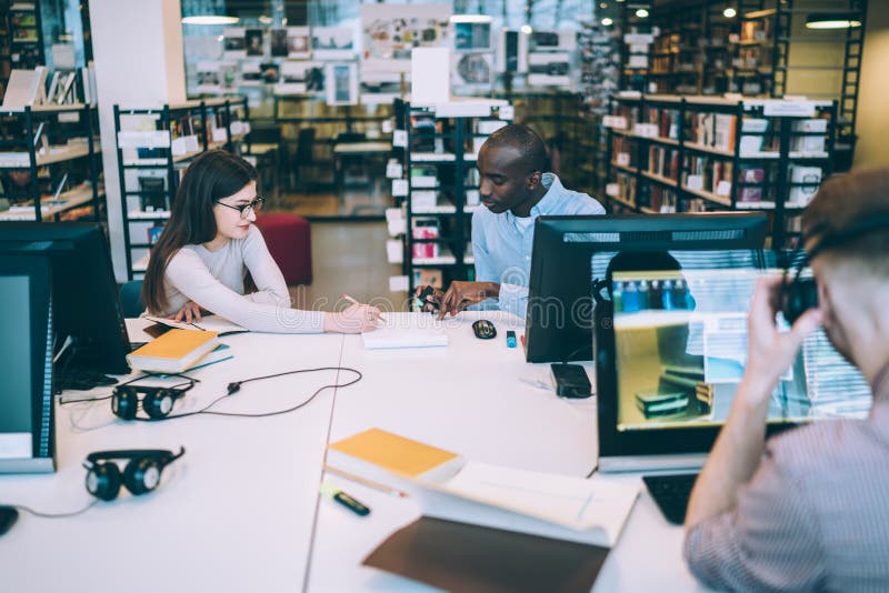 Inspired Multiracial Students Writing in Notebook Together and Using ...