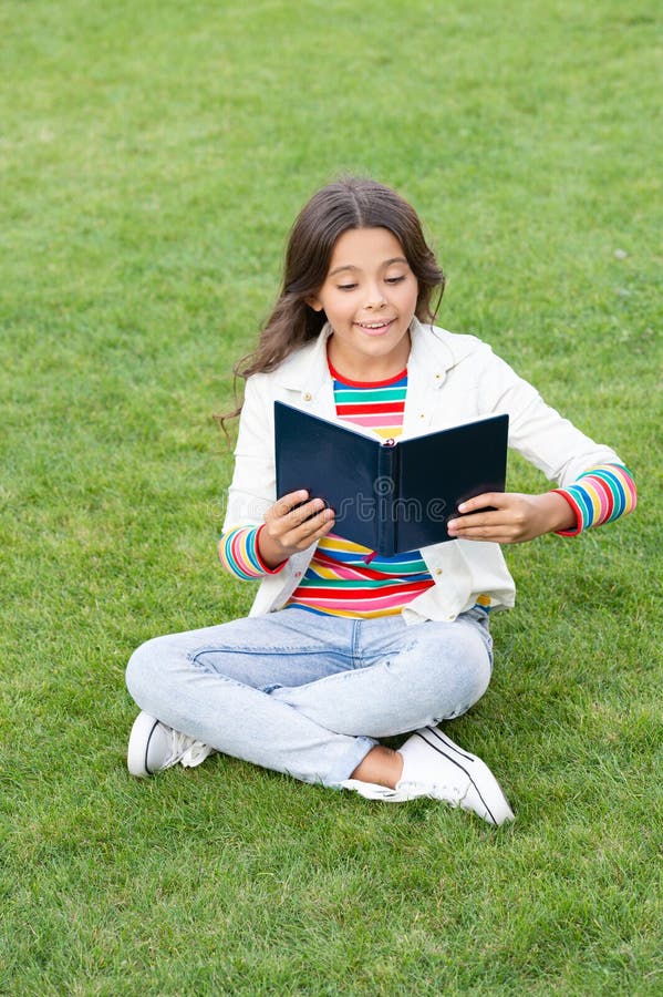 Inspired Teen Girl Read Book Sitting On Grass Reading Book Stock Image