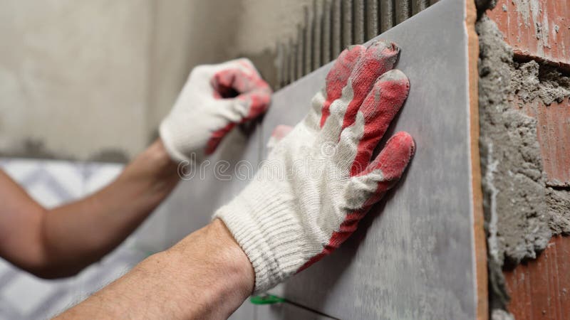 Instaling Ceramic Tiles. Male Hands Glue Ceramic Tiles on the Wall in ...