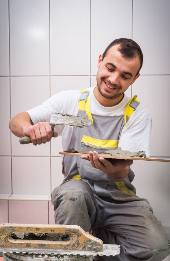 Install ceramic tiles stock image. Image of master, laying - 55885107