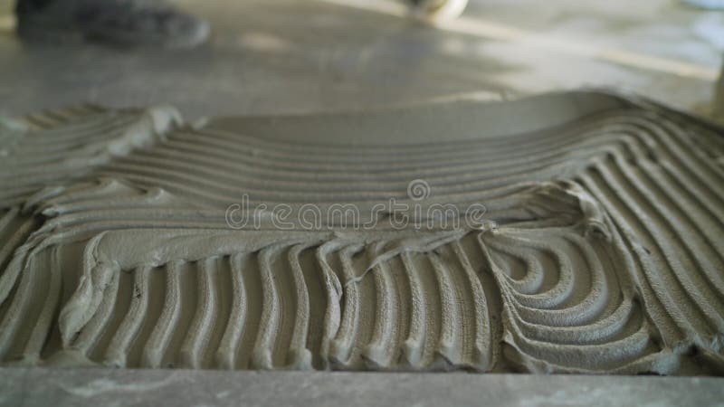 The Process of Applying Mortar for Laying Ceramic Tiles. Leveling ...