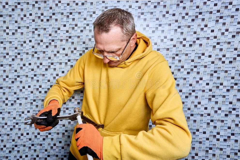 Plumber Uses Two Open End Wrenches To Tighten Securing Nut of ...