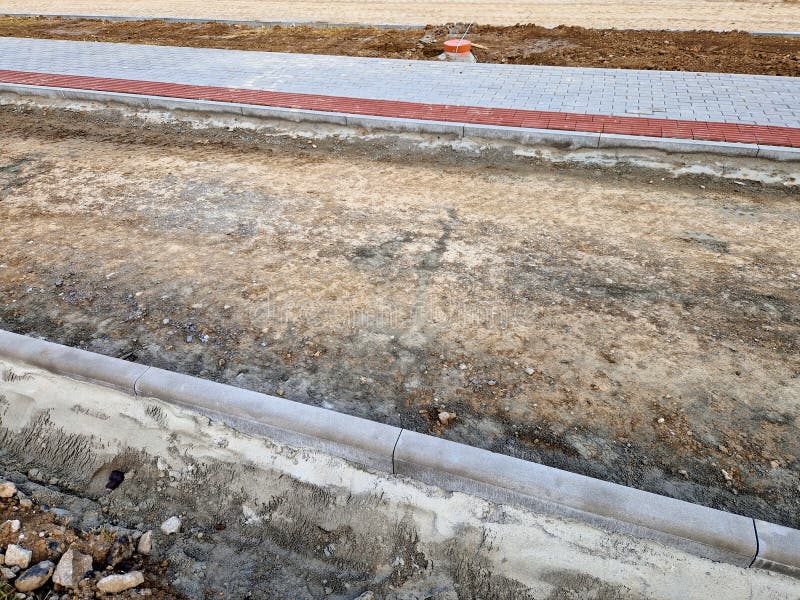 Installation of Concrete Curb into Concrete. in the Space of the Road ...