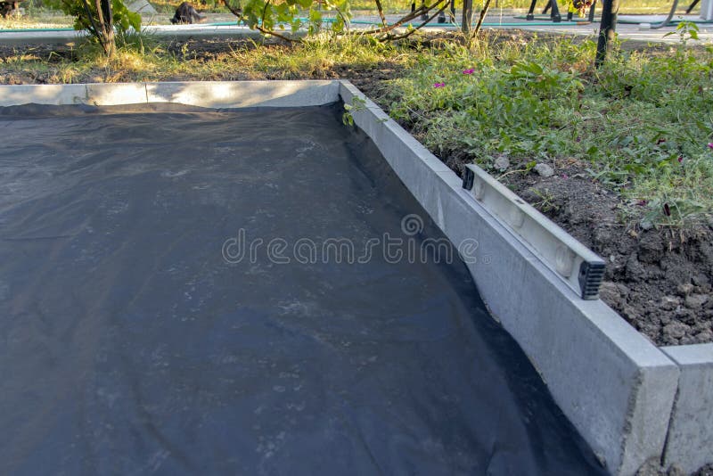 Installation of Curbs. Laying Curb Stones Using Concrete. Selective ...