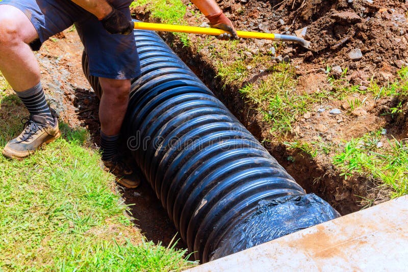 Installation of Drainage Black Pipe in a Trench during Construction ...