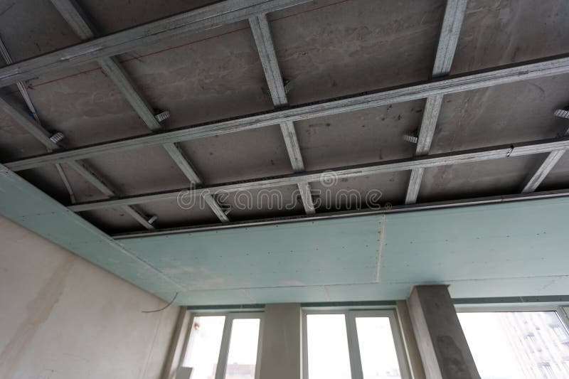 Installation of Drywall. Workers are Using Screws and a Screwdriver To ...