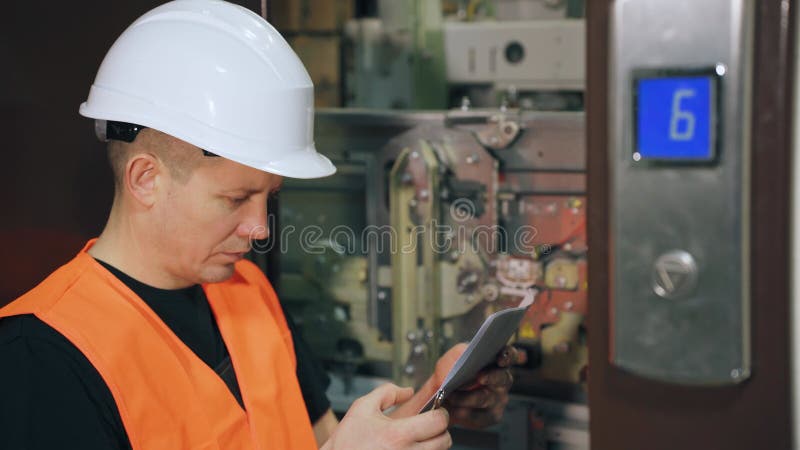 Installation of an Elevator Cabin in a Residential Complex. a Male ...