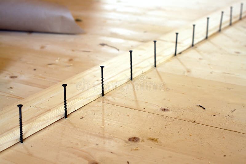 Installation of the Floor in a House. Screws Lined Up before Tightening ...