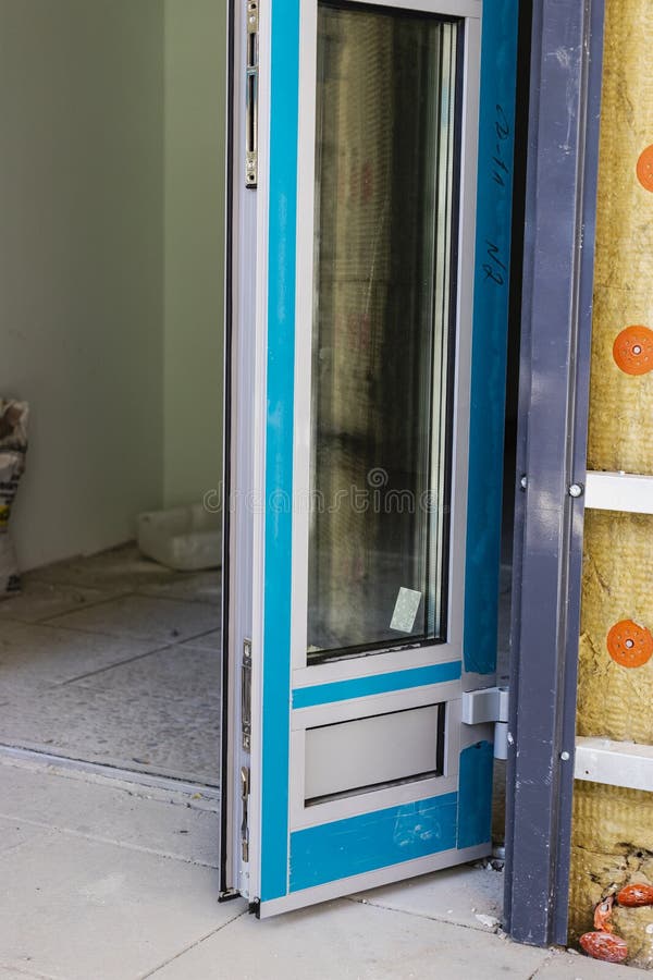Installation of a Glass Entrance Door in a Building Under Construction ...