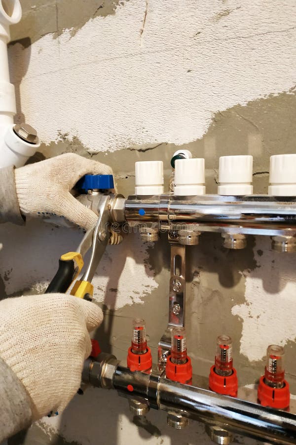 Installation of Heating a New Home, the Worker Connects the Pipe To the ...