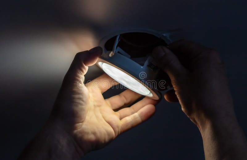 Installation of a Light Bulb in a Stretch Ceiling Stock Photo - Image ...