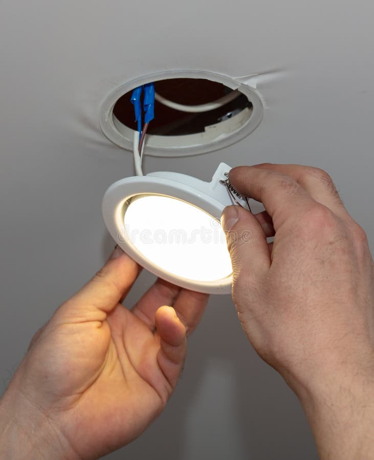 Installation of a Light Bulb in a Stretch Ceiling Stock Photo - Image ...