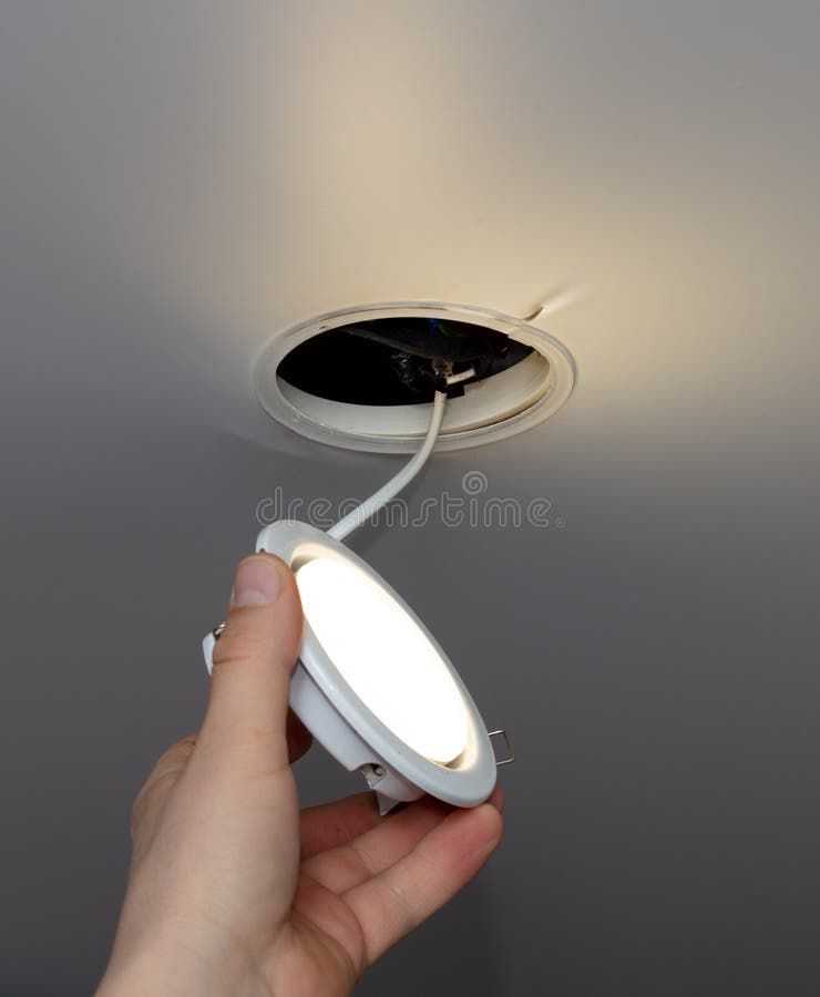 Installation of a Light Bulb in a Stretch Ceiling Stock Photo - Image ...