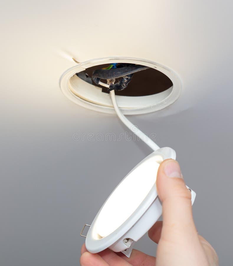 Installation of a Light Bulb in a Stretch Ceiling Stock Image - Image ...