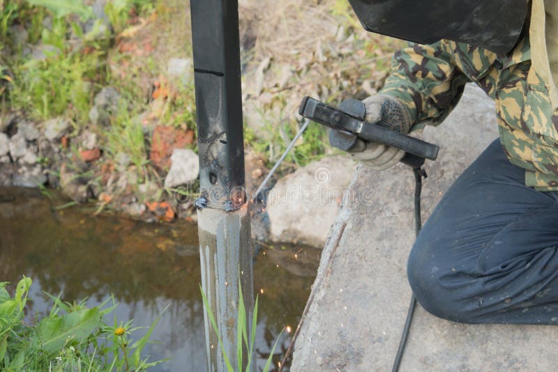 Installation of a Metal Column Using a Welding Machine Stock Photo ...