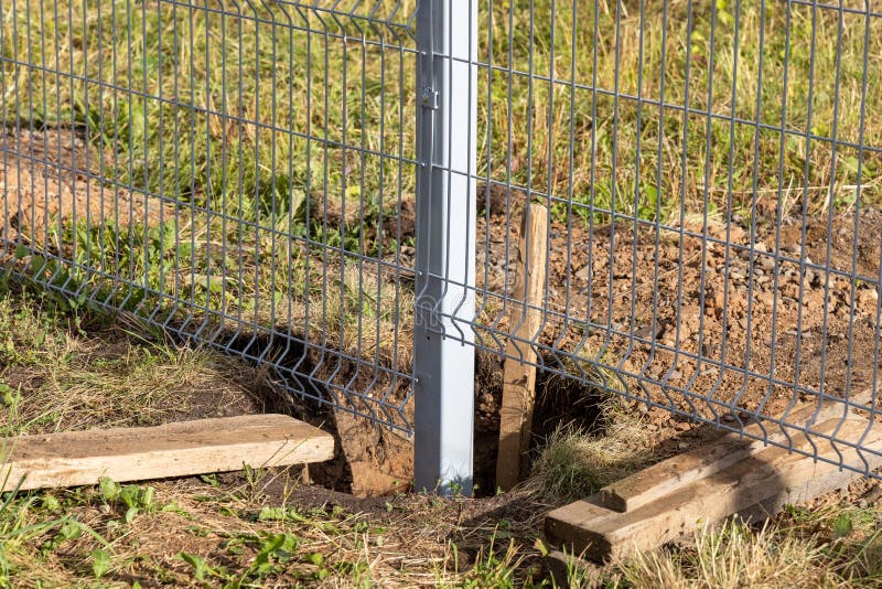 Installation of a Metal Fence. the Process of Installing Support Poles ... Installation of a Metal Fence. the Process of Installing Support Poles ...