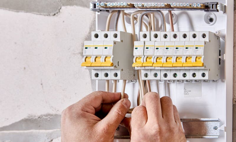 An Electrician Connects Wires To Fuse Box in Consumer Unit of ...