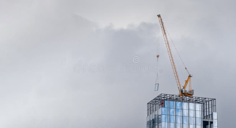 Installation of Panoramic Windows on a Skyscraper with a Crane. High ...