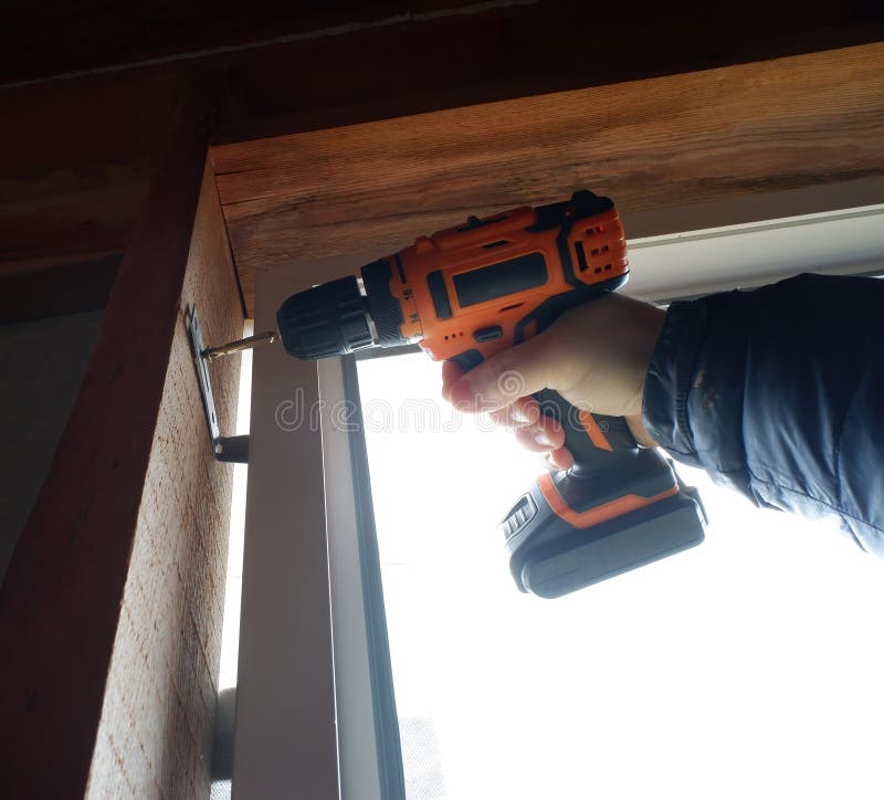 Installation of Plastic in a Frame House, the Builder Screws the Window ...