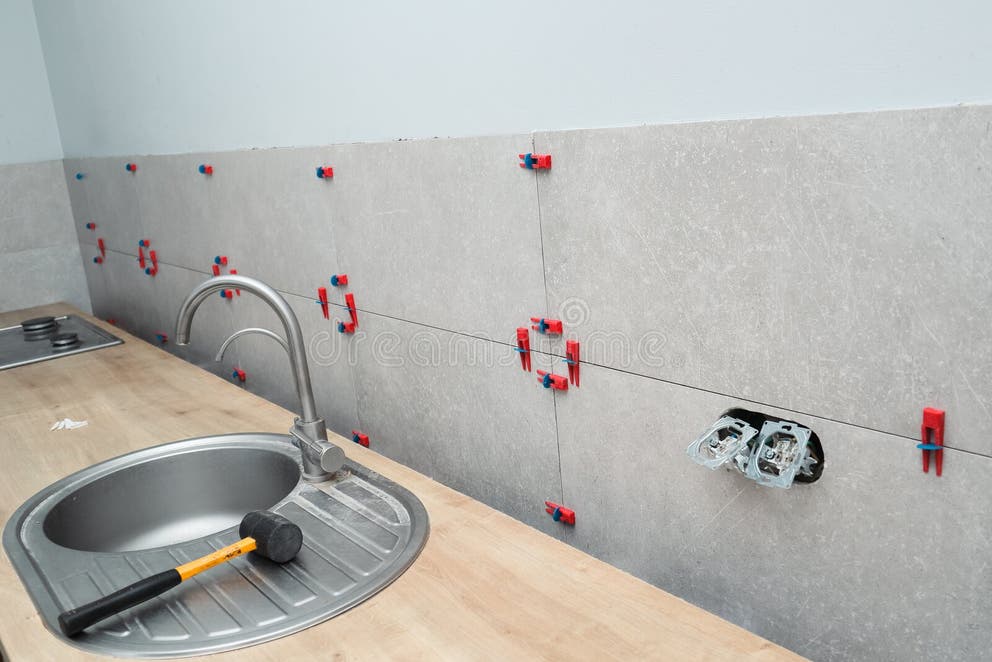 Installation of Porcelain Tiles on the Wall. Tile Leveling System Stock ...