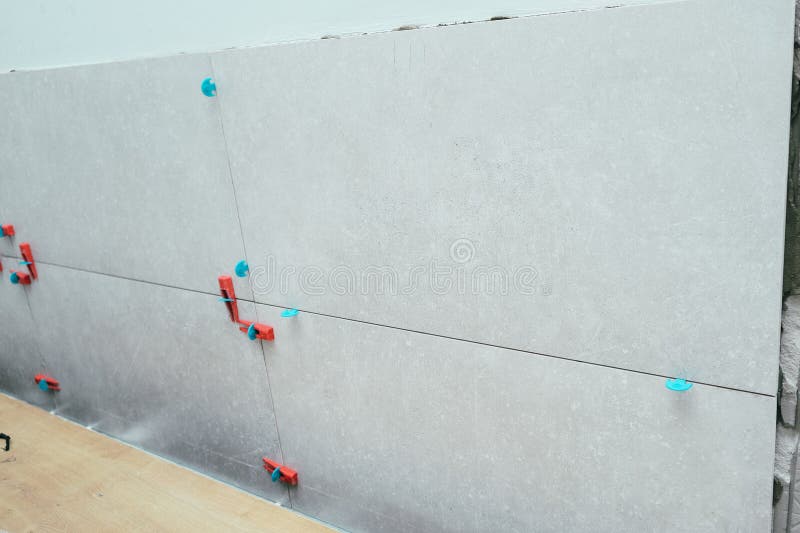 Installation of Porcelain Tiles on the Wall. Tile Leveling System Stock ...