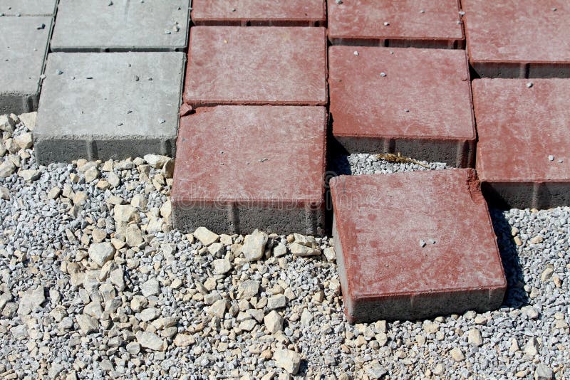 Installation of Rectangle Grey and Light Red Stone Tiles on Gravel at ...
