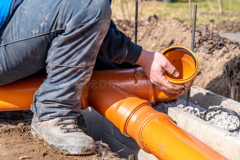 Installation of a Sewage Plastic Pipe during the Construction of a ...