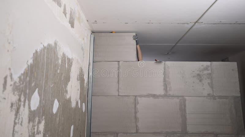 Construction Work with a Ceramist and Tiler. Installation of Sheet ...