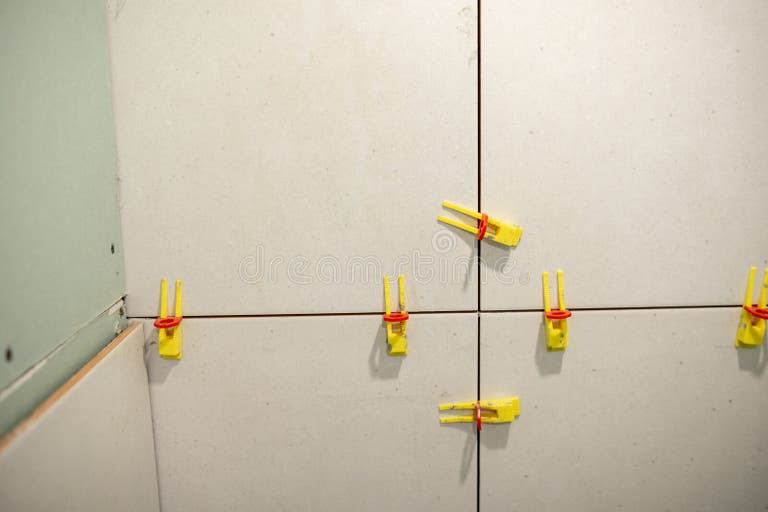 Installation of Tile Leveling Clips on a Construction Wall in a Home ...