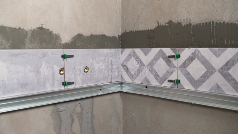 Installation Wall Tile. Worker Laying Tiles on the Wall. . Ceramic ...
