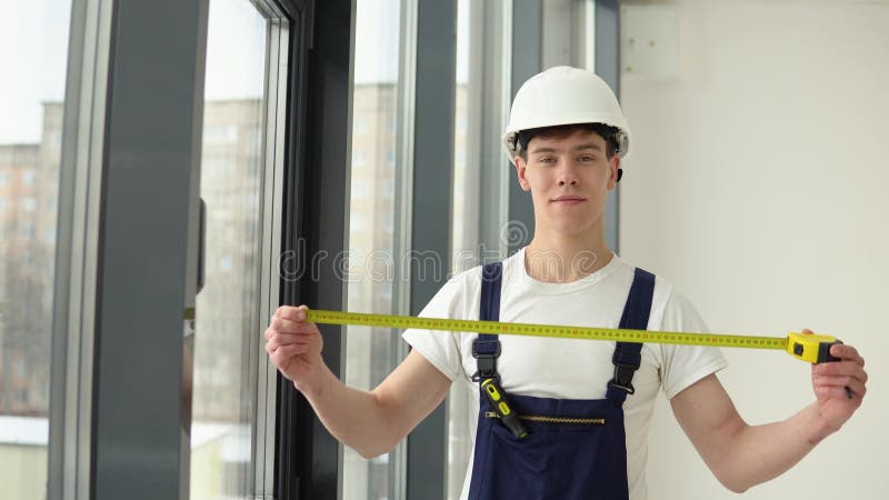 The Window Installer Measures the Dimensions of the Window Frame with a ...