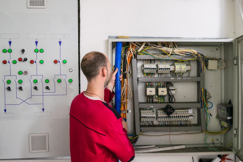 The Installer is Laying the Cable in an Electrical Box. the Electrician ...