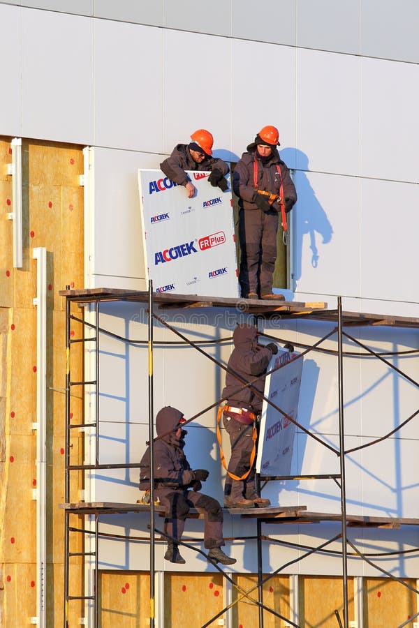 Installers are Engaged in Installing the Facade Panels of a Multi ...