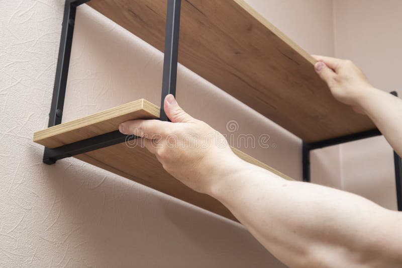 Installing Bookshelves on a Drywall Wall. Self-installation Stock Photo ...