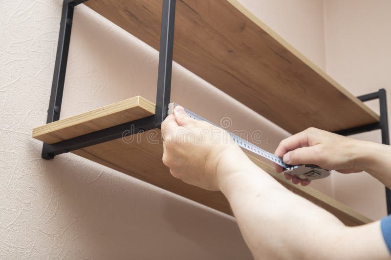 Installing Bookshelves on a Drywall Wall. Self-installation Stock Photo ...