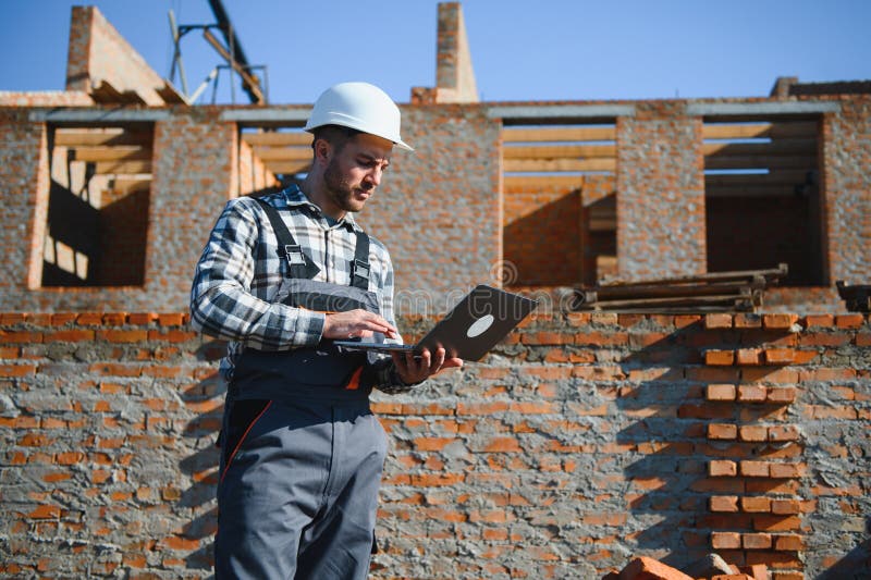 Installing Brick Wall. Construction Worker in Uniform and Safety ...