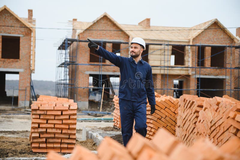 Installing Brick Wall. Construction Worker in Uniform and Safety ...