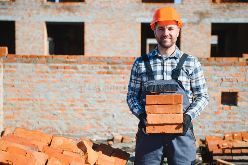 Installing Brick Wall. Construction Worker in Uniform and Safety ...