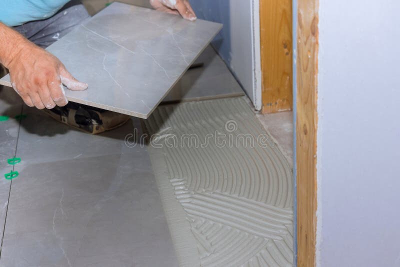 Installing Ceramic Floor Tiles on an Adhesive Surface Stock Image ...