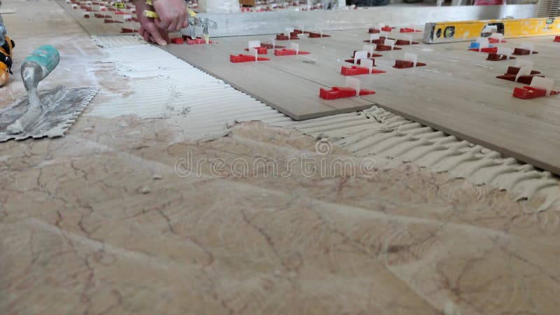 Installing Ceramic Floor Tiles, Placing the Tile into the Adhesive ...