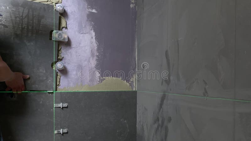Installing Ceramic Wall Tiles. Professional Builder Worker Installing ...