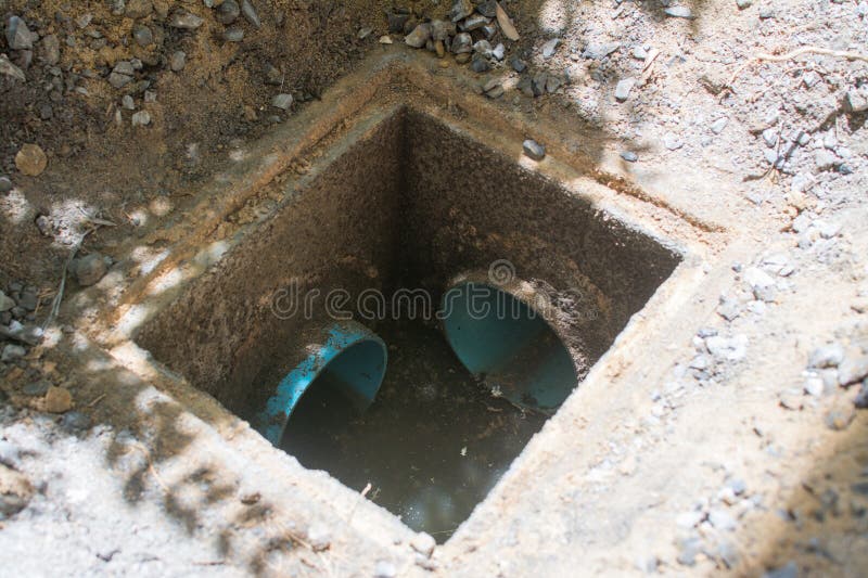 Installing Concrete Manhole with Drain Pipes at Construction Site Stock ...