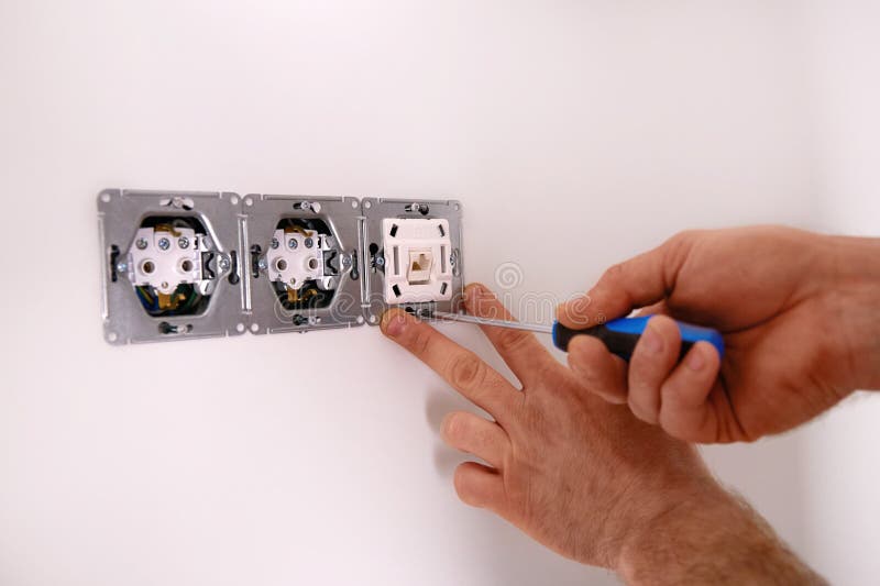 Installing an Electrical Outlet with a Screwdriver in a Modern Interior ...