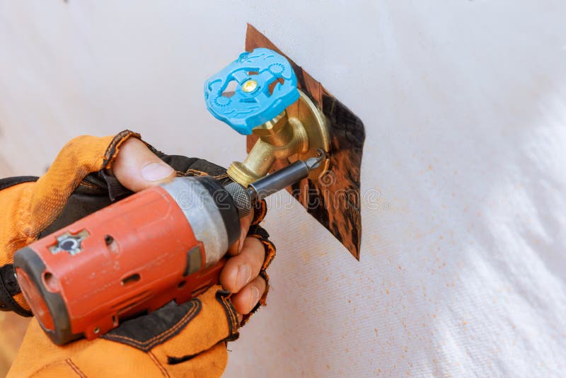 Installing External Water Taps on Facade of Residence by a Plumber ...