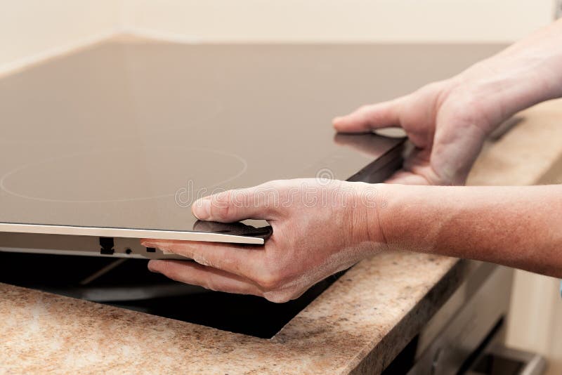 Installing induction hob stock image. Image of blue, induction - 33124483