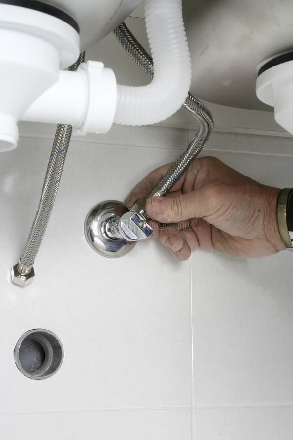 Installing a kitchen sink stock image. Image of plumbing - 131576859