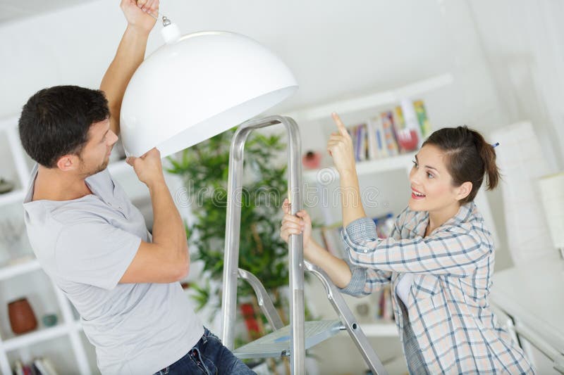 Installing lamp at home stock photo. Image of amateur - 311726664